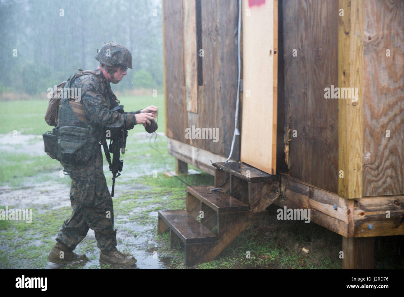 A Marine prepares a detonation linear charge during an urban breaching ...