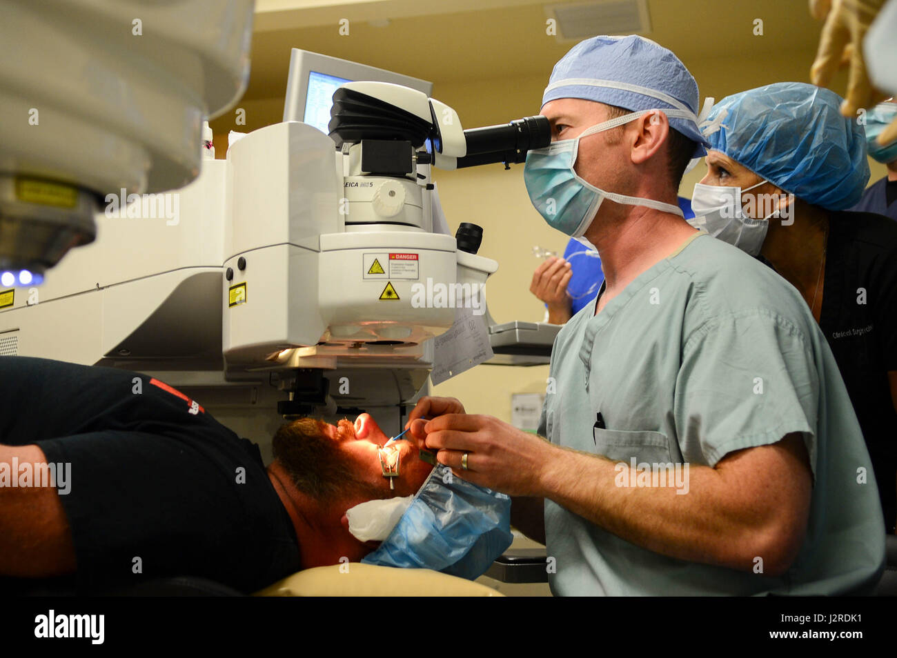 Navy personnel perform a KAMRA corneal inlay procedure to treat ...