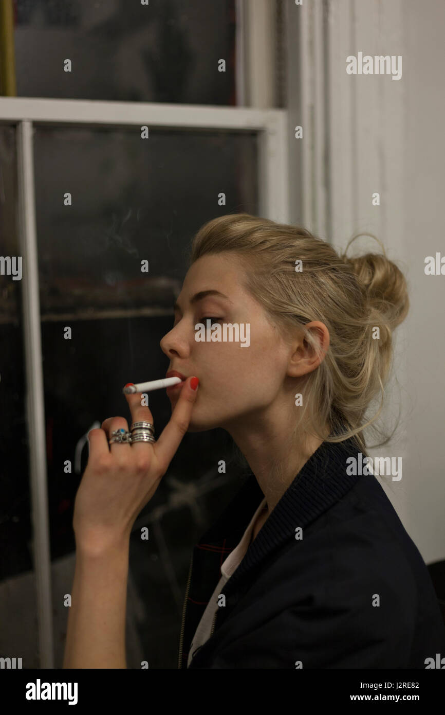 Side view young woman smoking hi-res stock photography and images - Alamy
