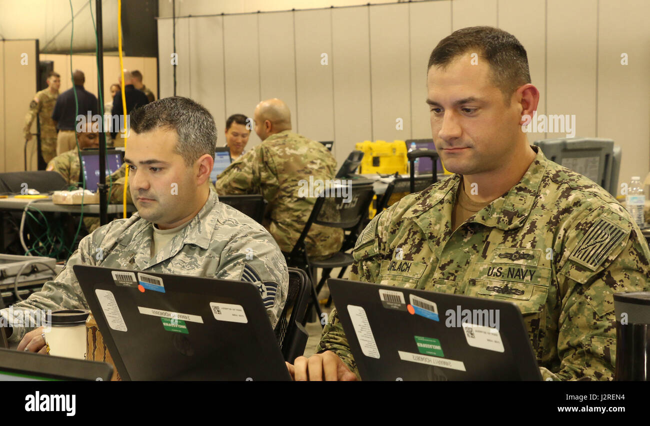 An Air Force Airman and a Navy Sailor, members of Joint Task Force ...