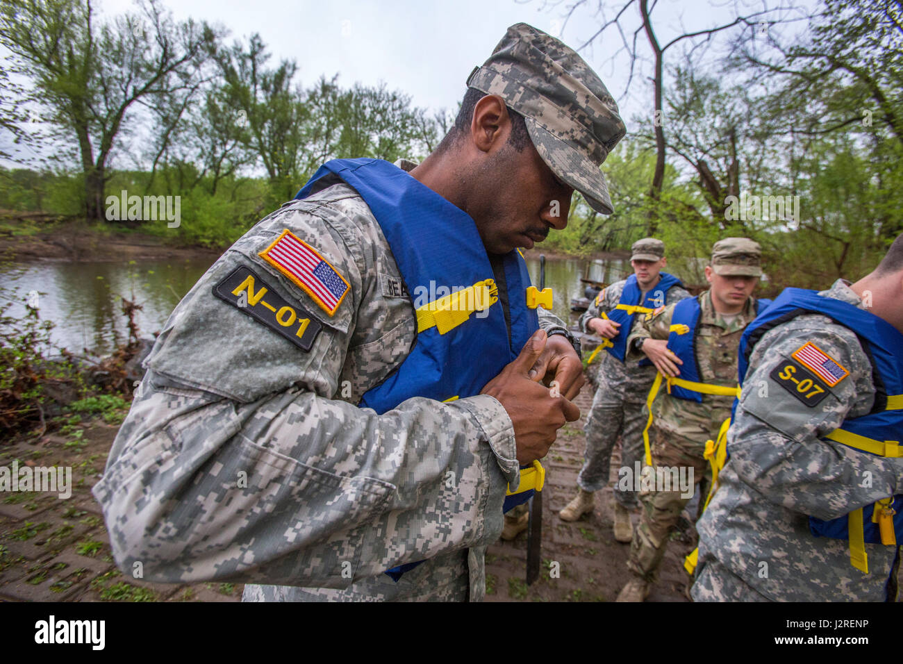 U.S. Army Sgt. Daniel Beachum, New Jersey Army National Guard, puts on ...