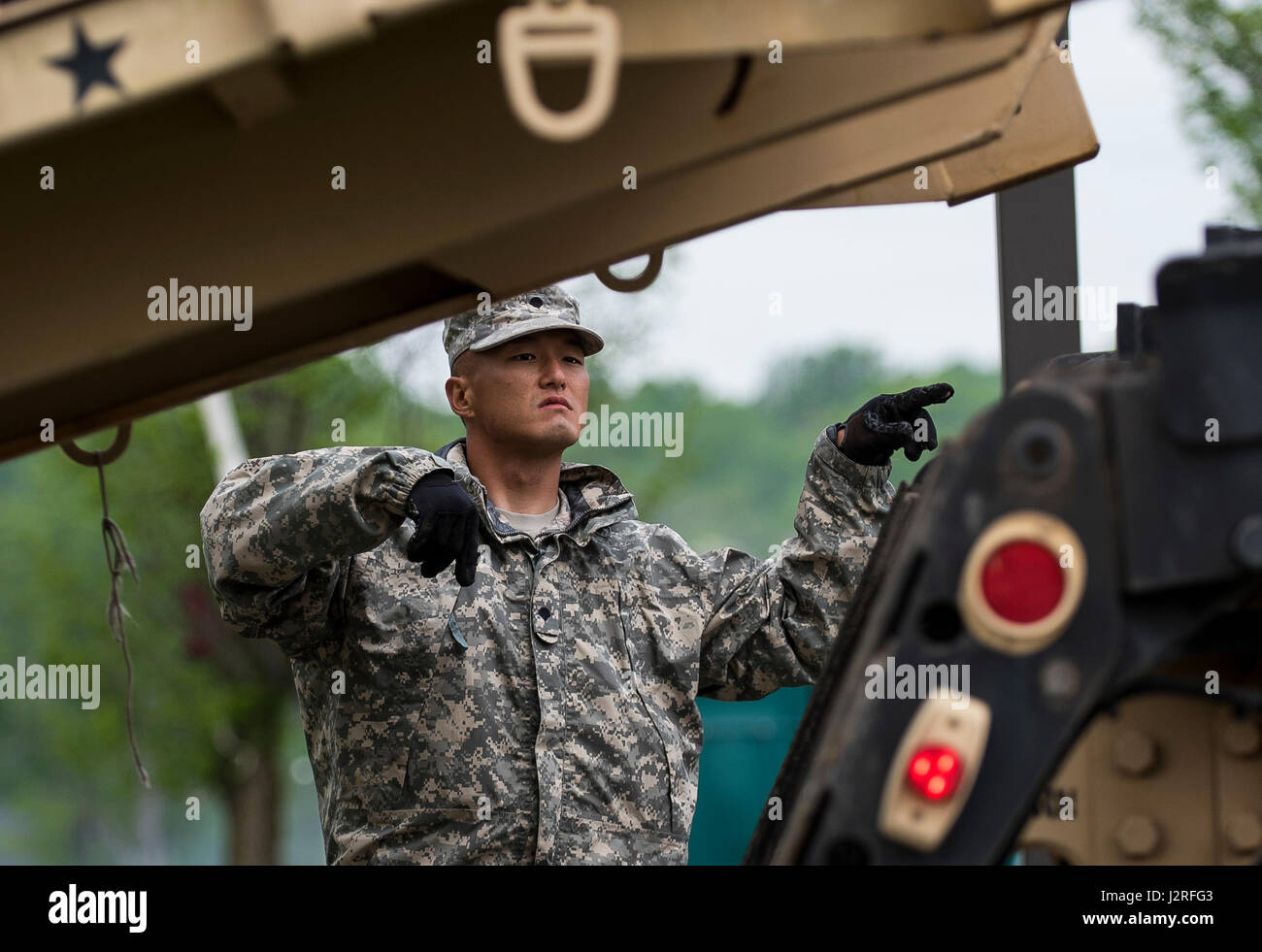 U.S. Army Soldiers from the 51st CBRN Company guide equipment during ...
