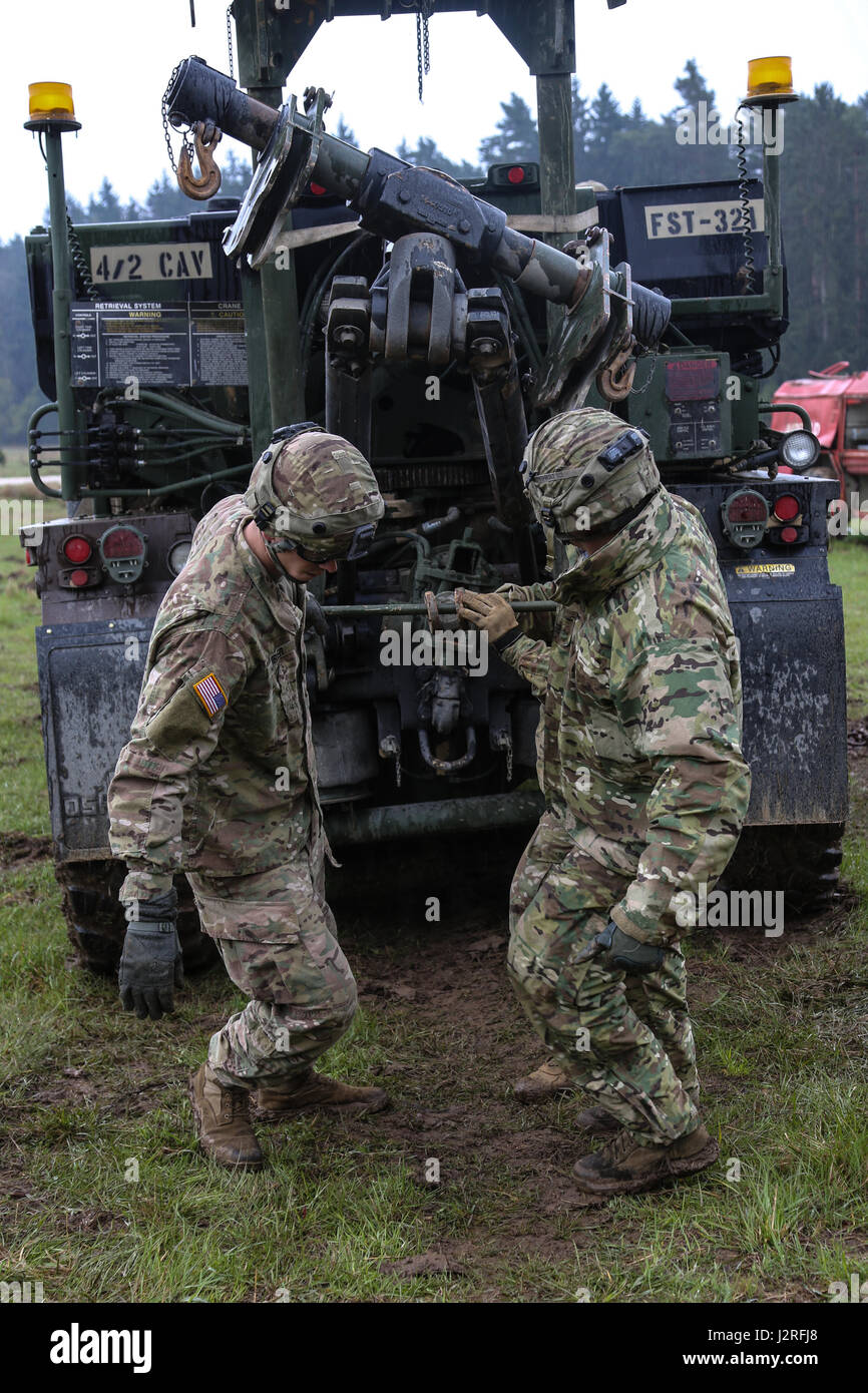 U.S. Soldiers of 4th squadron, 2nd Cavalry Regiment withdraw the winch ...