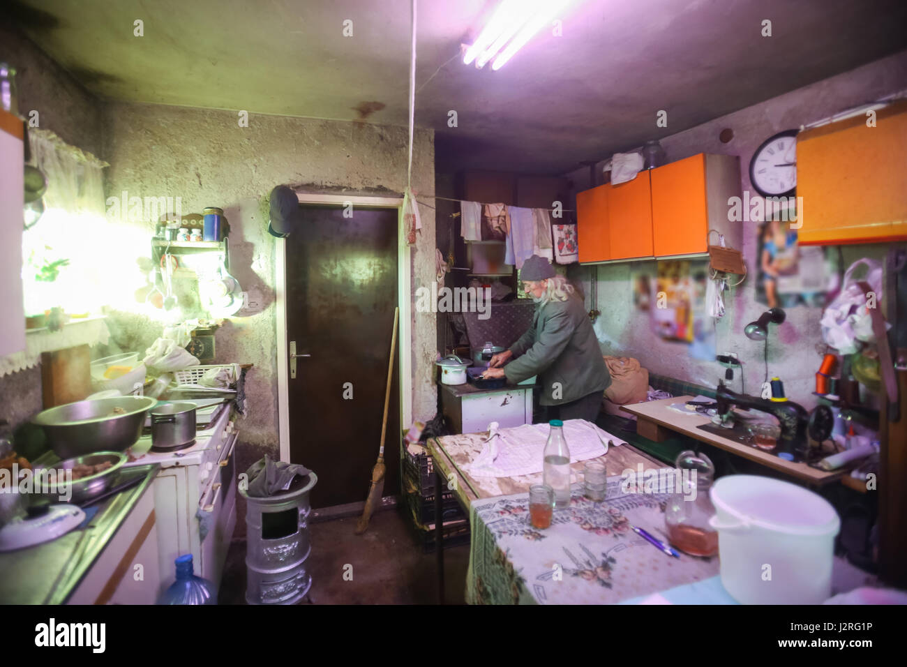 An old man cooking on the stove in an obsolete rustic kitchen Stock ...