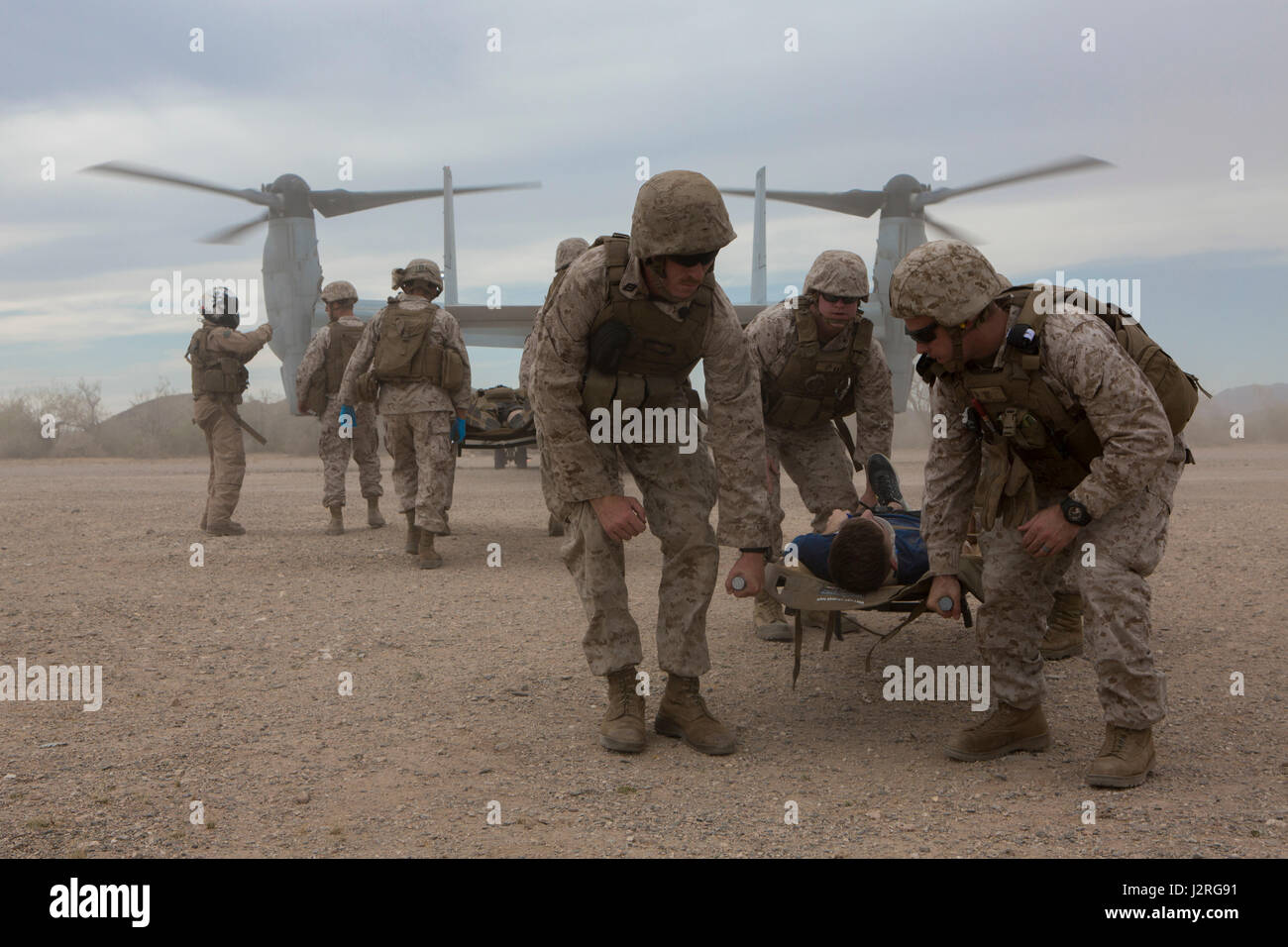 U.S. Navy Corpsmen with the 15th Marine Expeditionary Unit transport a ...