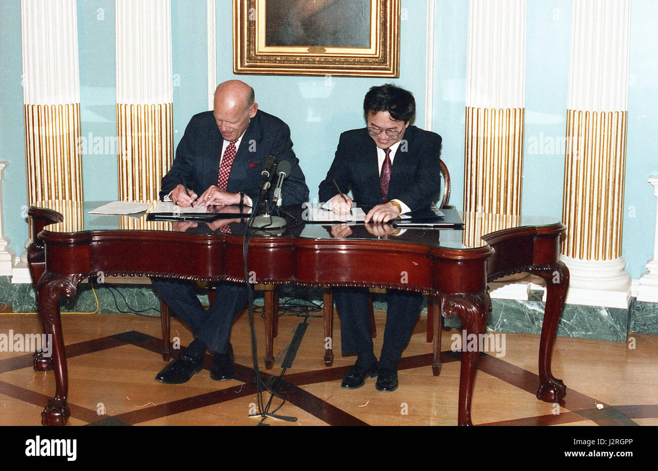 men signing papers Stock Photo - Alamy