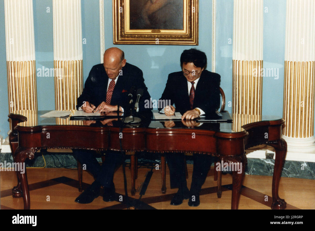Military personnel are shown signing official documents and ...