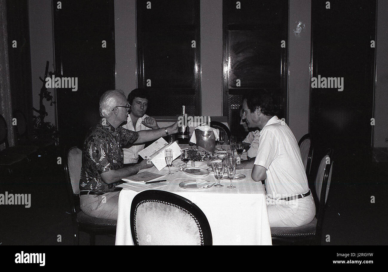 MEN SITTING AT A DINING TABLE Stock Photo - Alamy