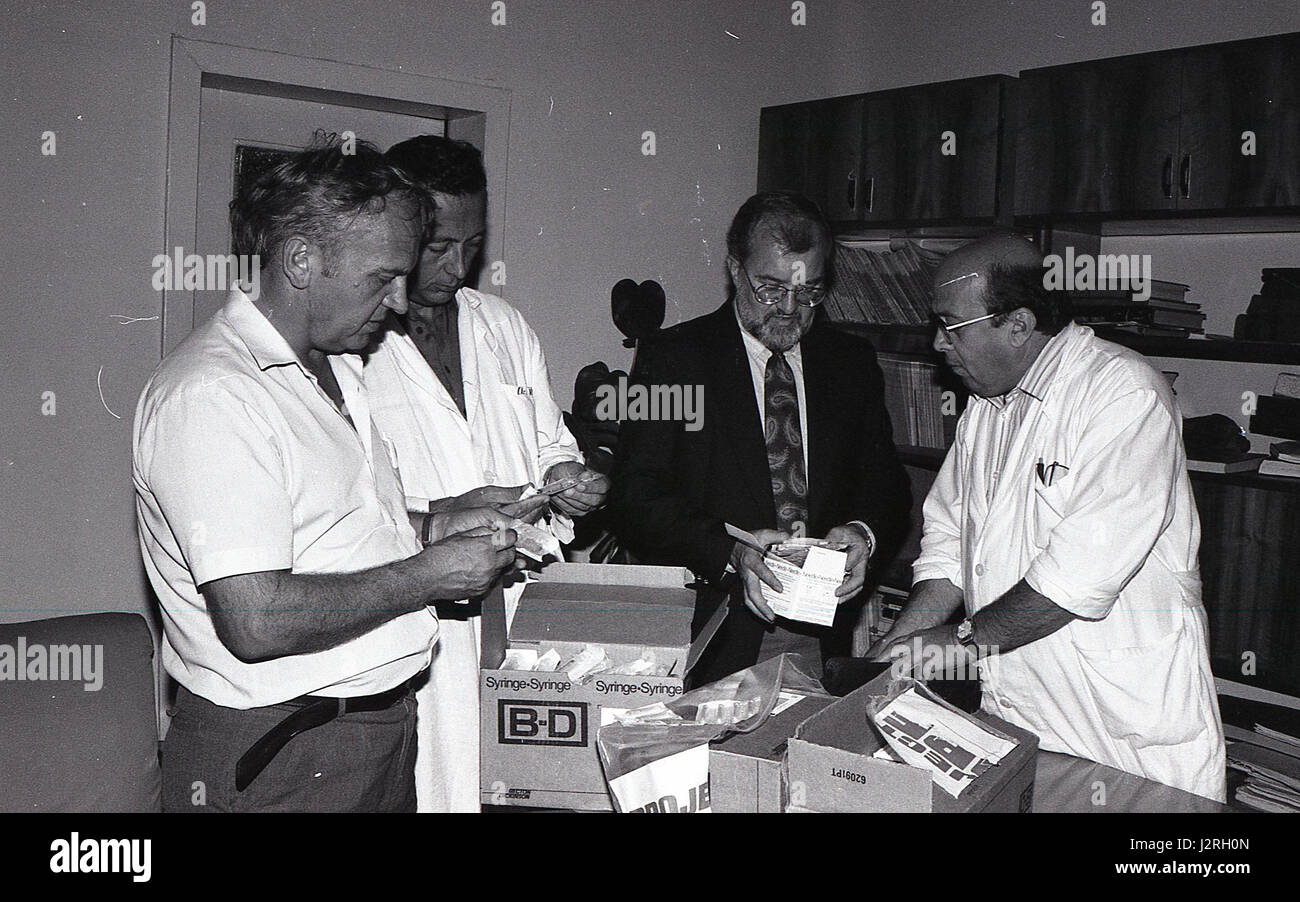 MEN OBSERVING OBJECTS IN A BOX Stock Photo - Alamy