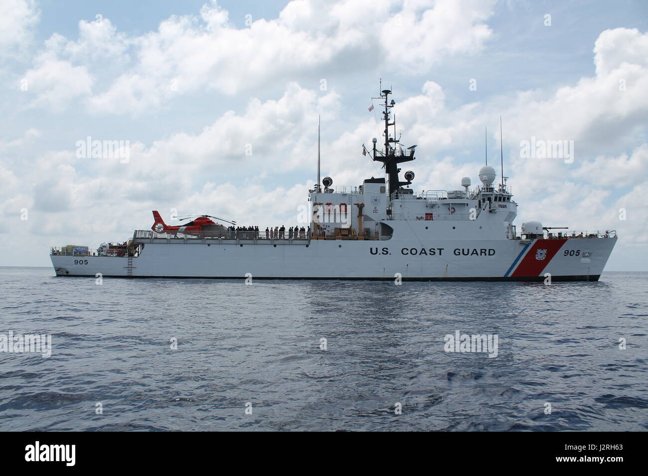 U.S. Coast Guard Cutter Spencer patrols the Atlantic Ocean with a MH-65 ...