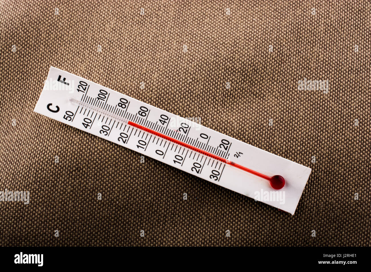 Thermometer placed on a brown rope on a fabric background Stock Photo ...