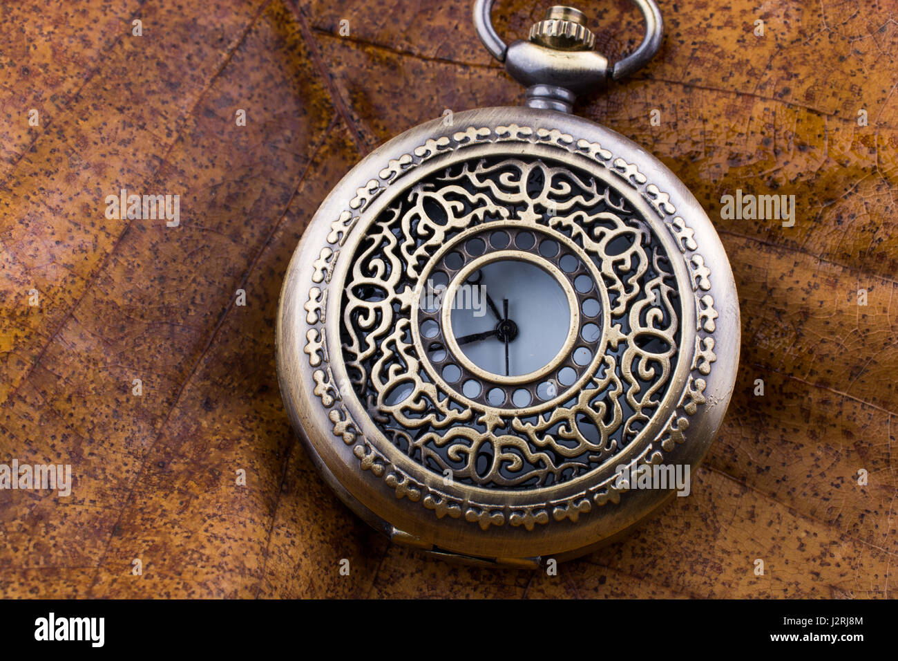 Retro style pocket watch placed on a piece of fabric Stock Photo - Alamy