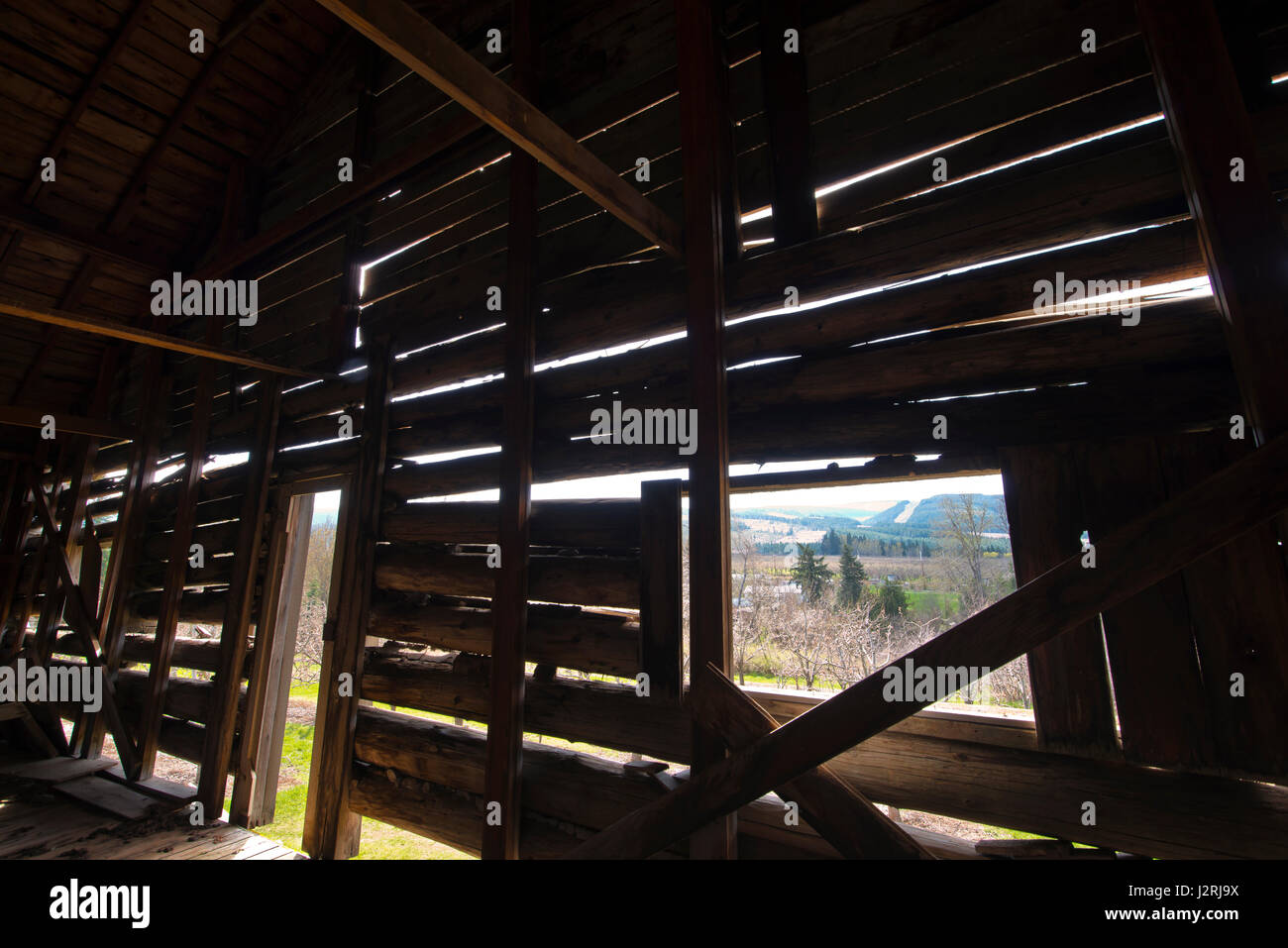 Wooden wall of an old house with slits and windows and doorways through ...