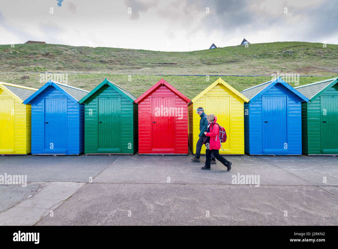 Row of brightly coloured wooden beach huts along the West Cliff ...