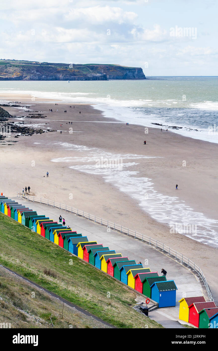 Row of brightly coloured wooden beach huts along the West Cliff ...
