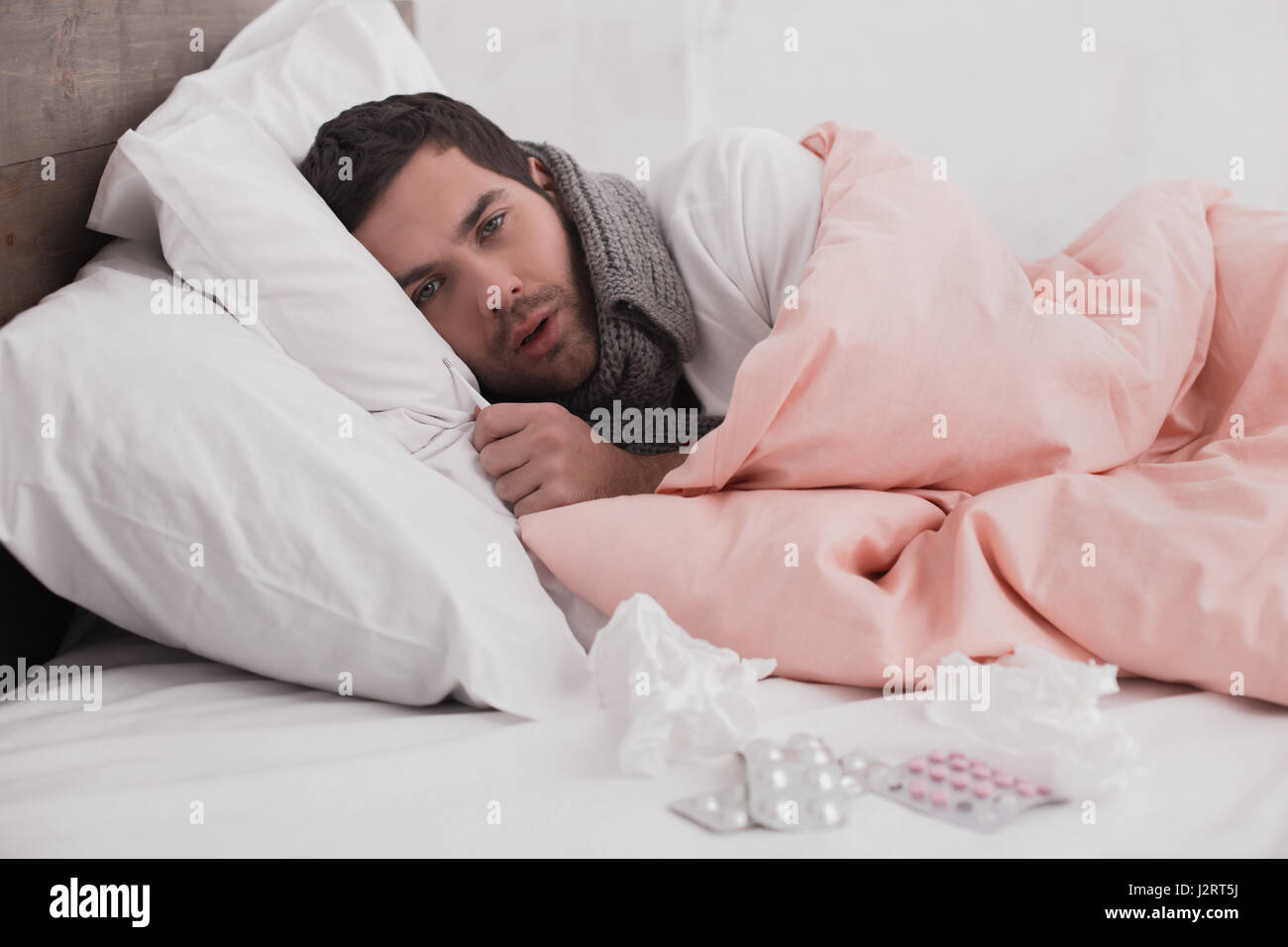 Sick young man fever concept Stock Photo - Alamy