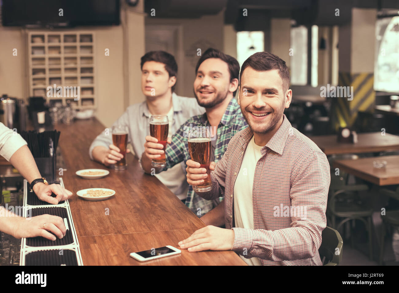 Friends having fun in pub Stock Photo - Alamy