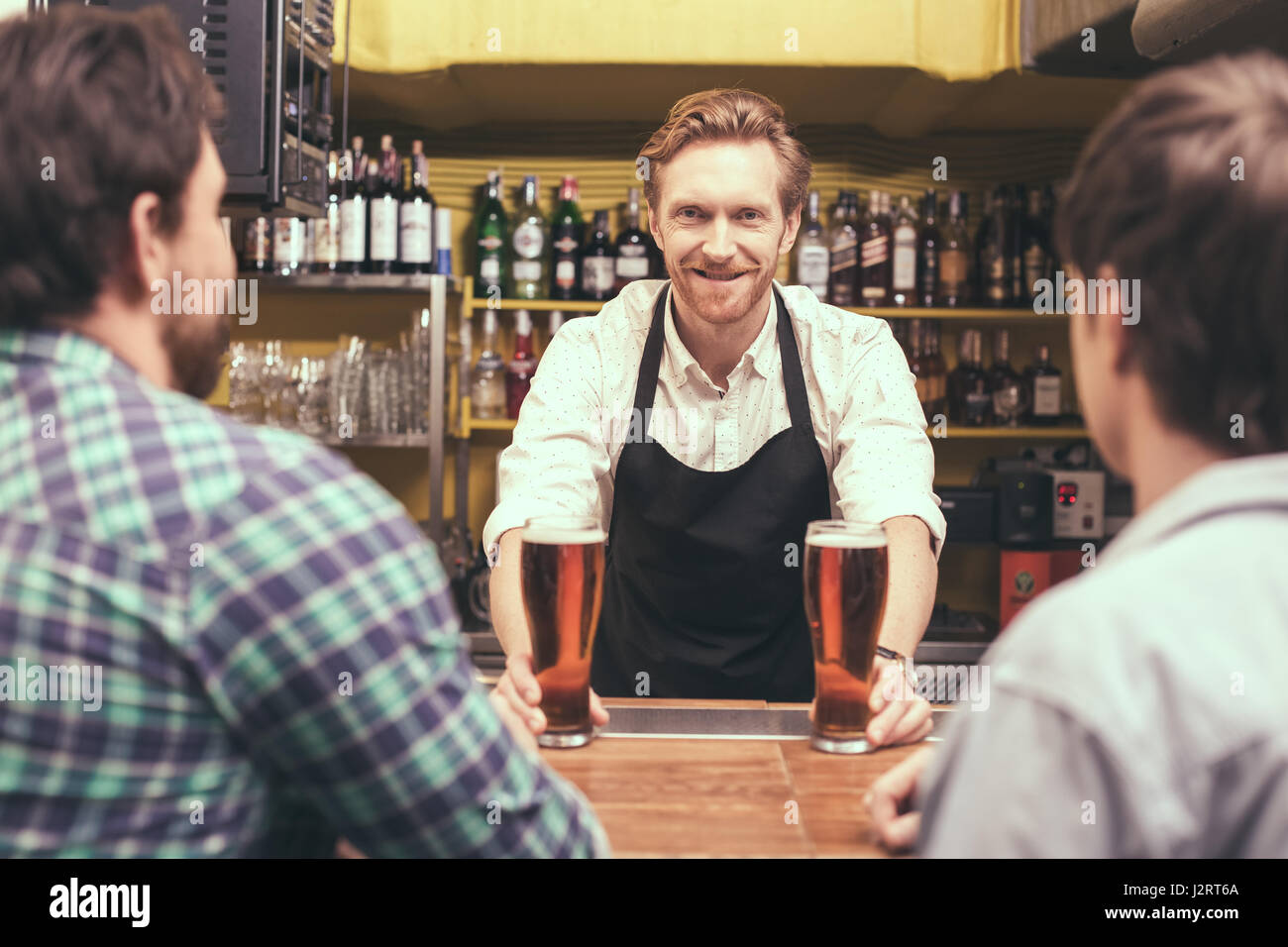 Friends having fun in pub Stock Photo - Alamy