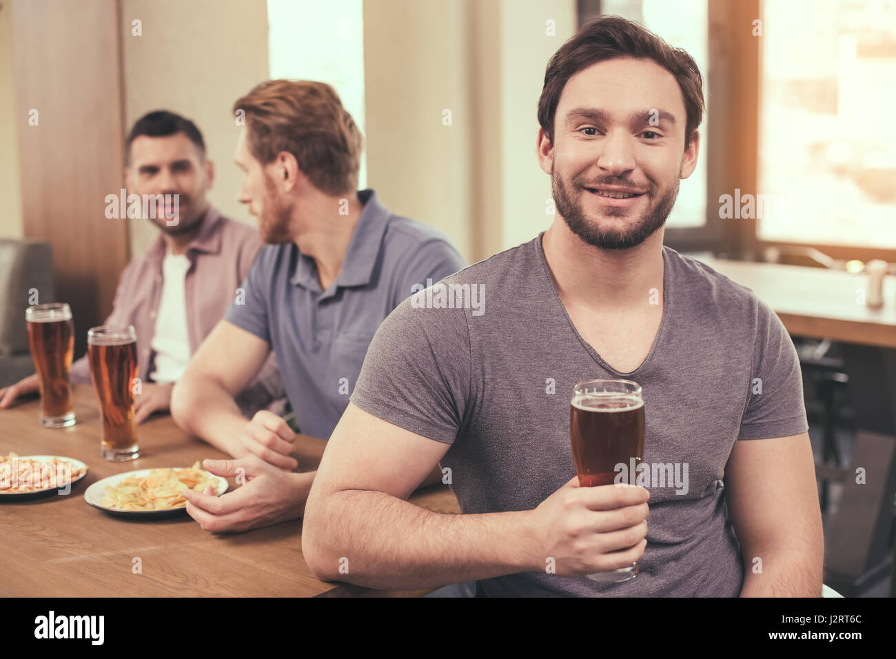 Friends having fun in pub Stock Photo - Alamy