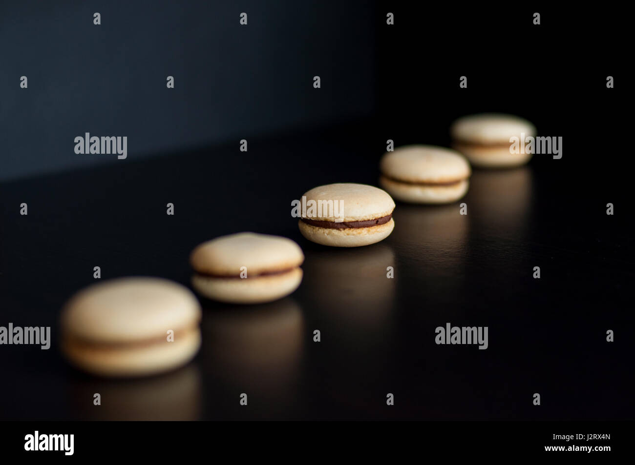 Macaroons with chocolate cream ordered in line Stock Photo - Alamy