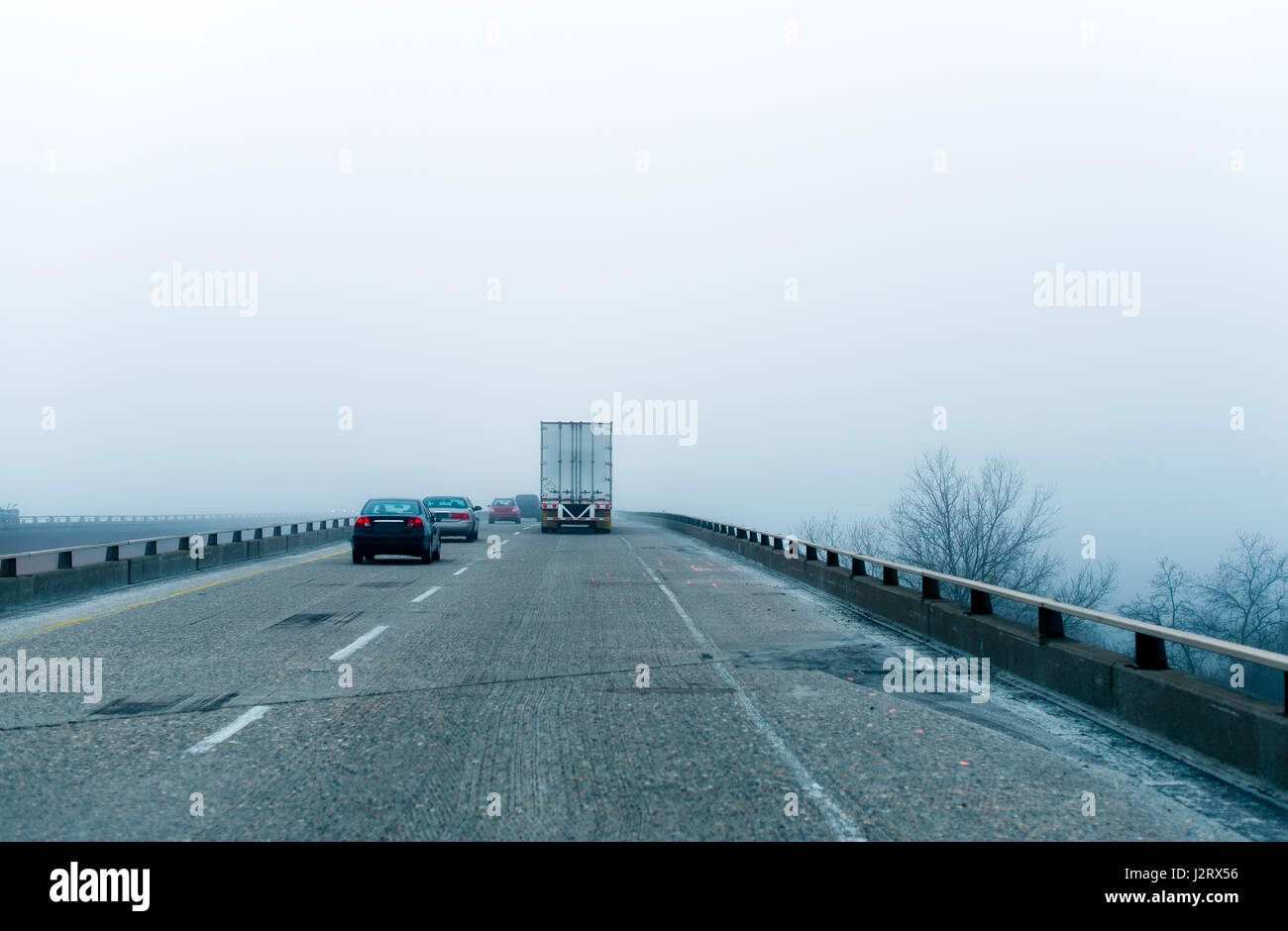 The highway road surfaced with concrete and metal fencing for security ...