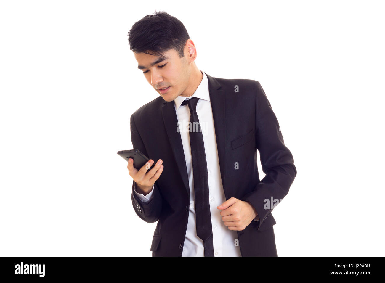 Young man in suit talking on the phone Stock Photo - Alamy
