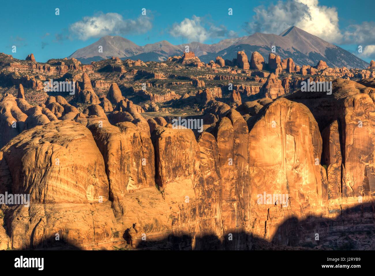 Sandstone domes and fins, steep cliffs, and natural arches erupt out of ...