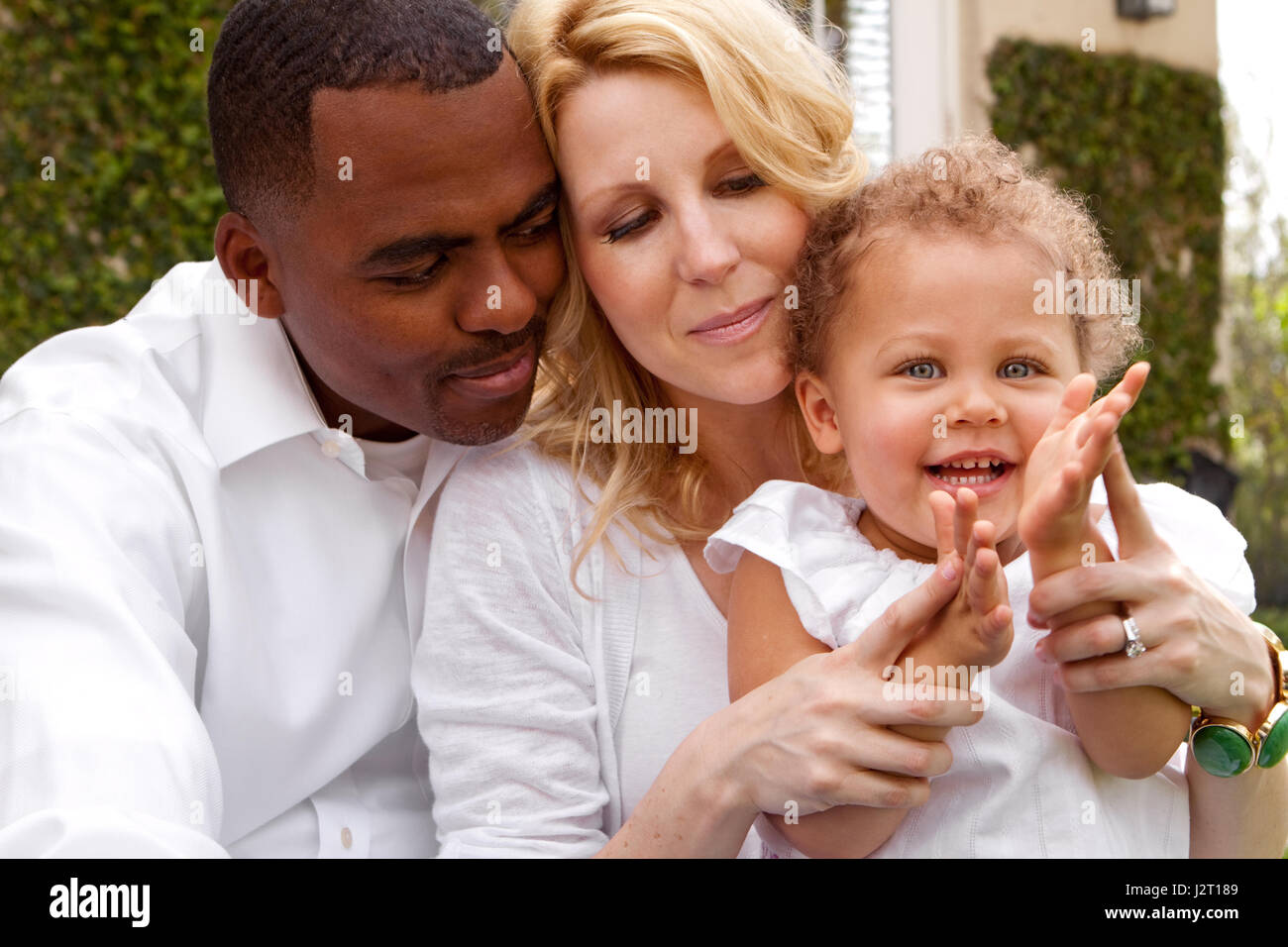 Portrait of happy multicultural family smiling Stock Photo - Alamy