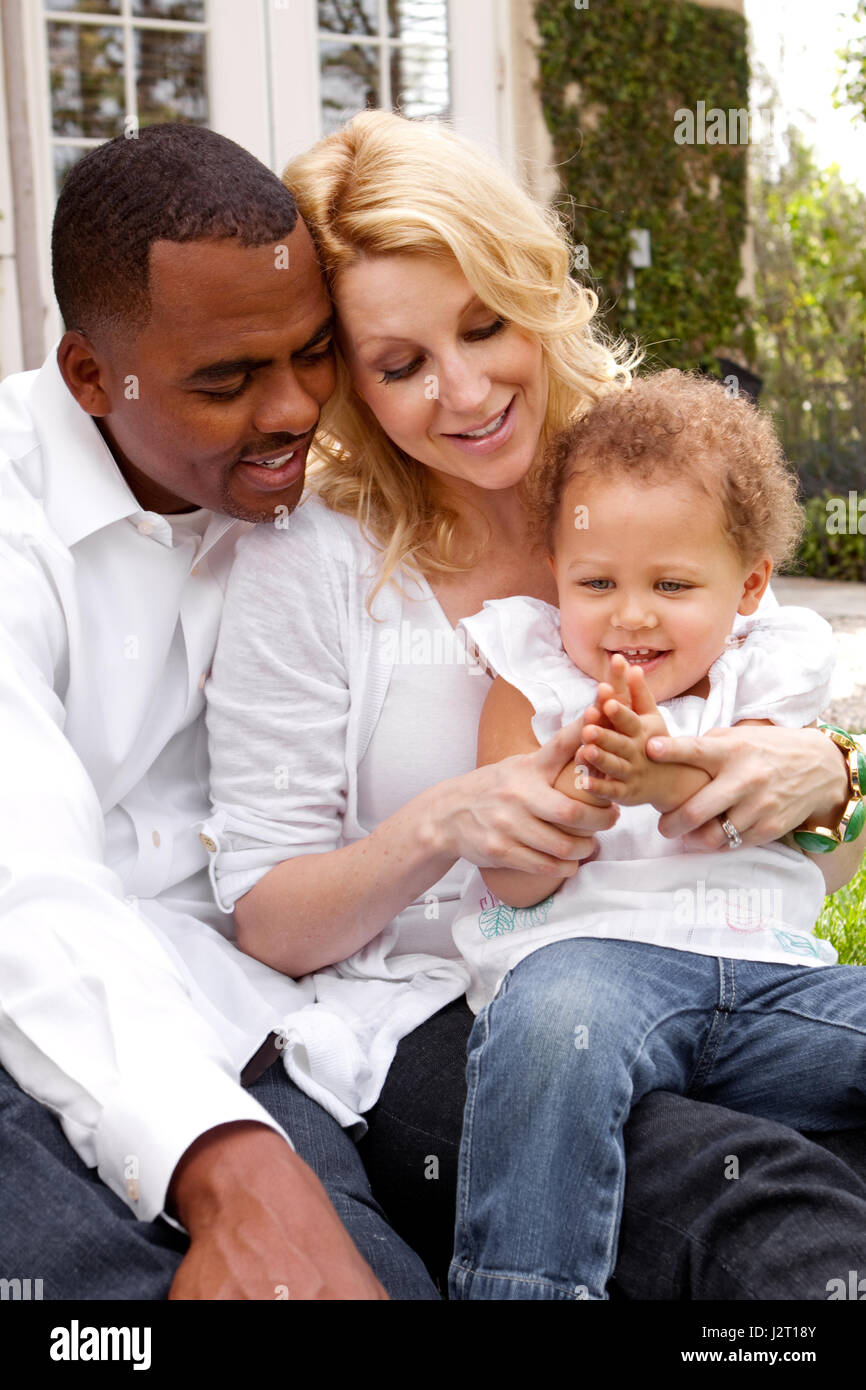 Portrait of happy multicultural family smiling Stock Photo - Alamy