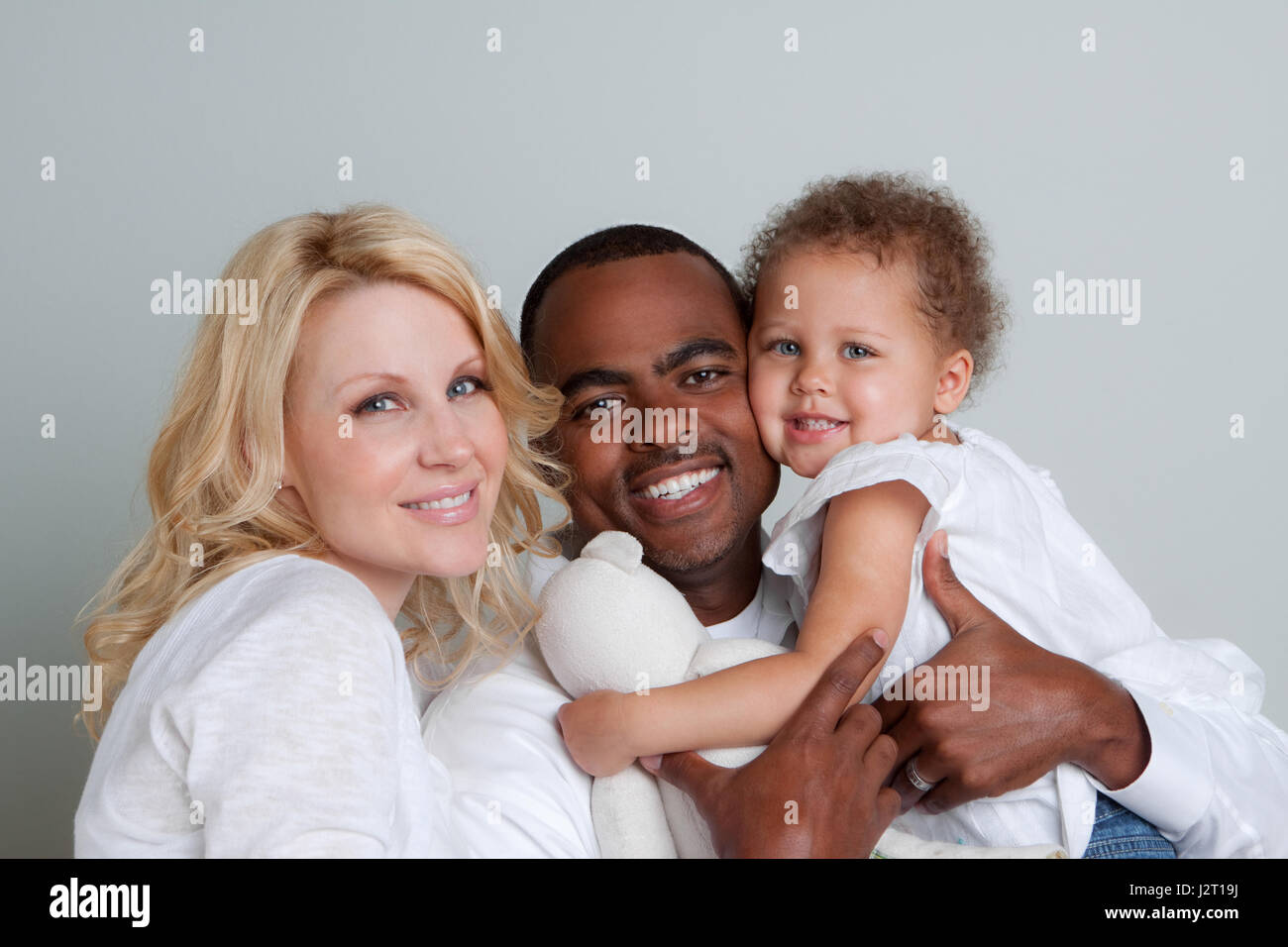 Portrait of happy multicultural family smiling Stock Photo - Alamy