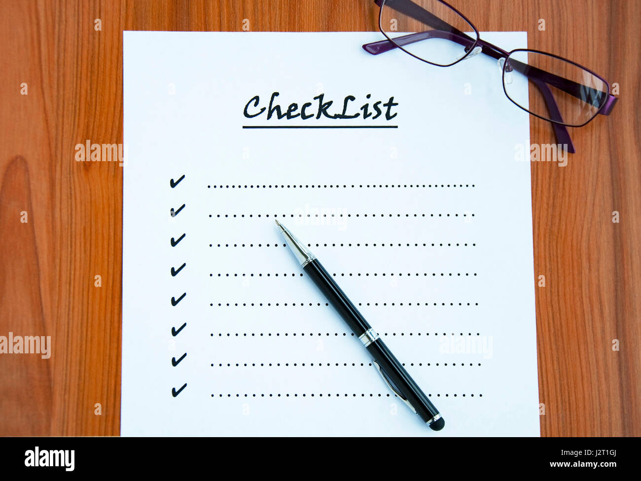 blank checklist on wooden table With a pen and glasses Stock Photo - Alamy