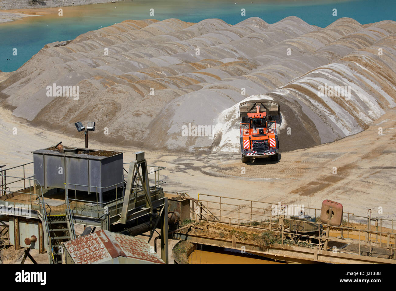 Diggers at Cemex Quarry in Dove Holes High Peak district of Derbyshire ...