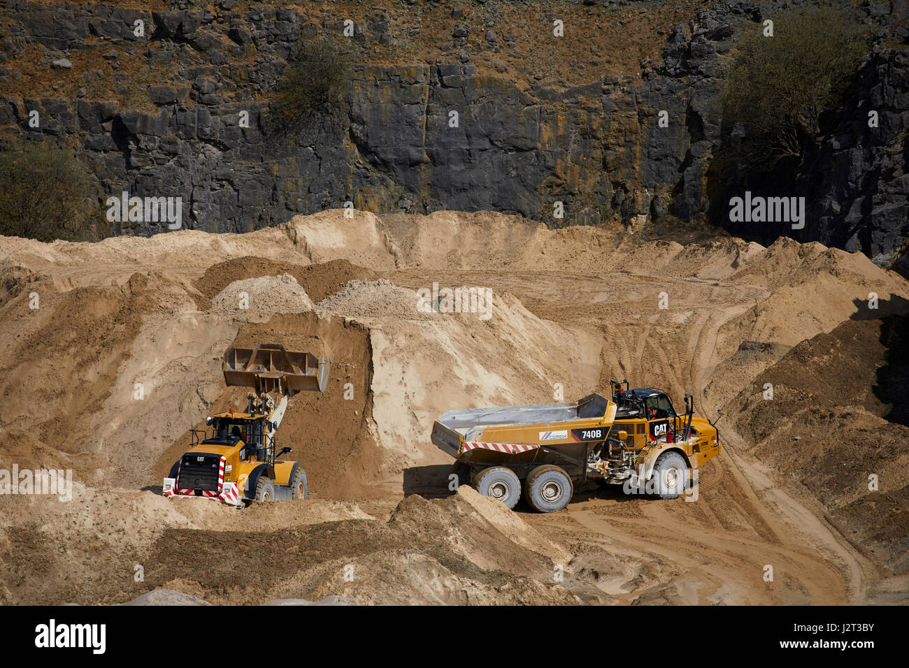 Diggers at Cemex Quarry in Dove Holes High Peak district of Derbyshire ...