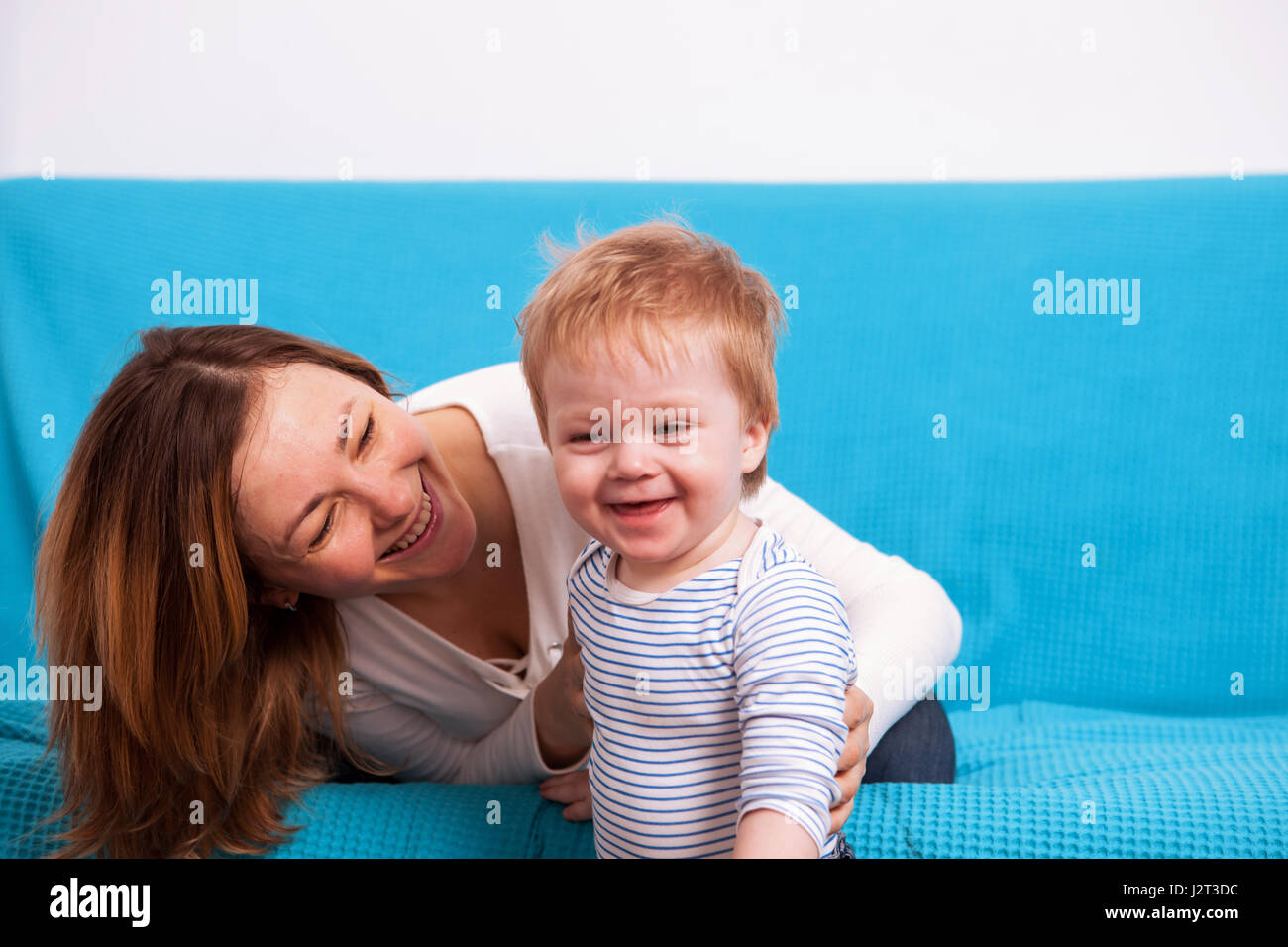 Laughing Mother and son playing together Stock Photo - Alamy