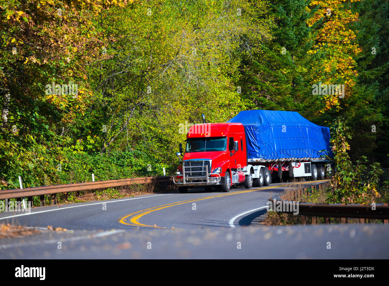 Powerful heavy huge bright red modern professional long haul semi truck ...