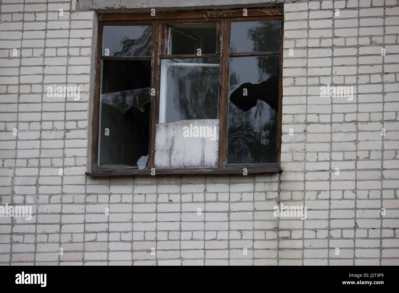 Broken windows in an old abandoned brick building Stock Photo - Alamy
