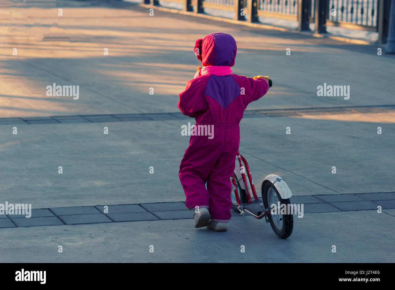 Happy child riding a bike. Little girl on a pink bicycle Stock Photo ...