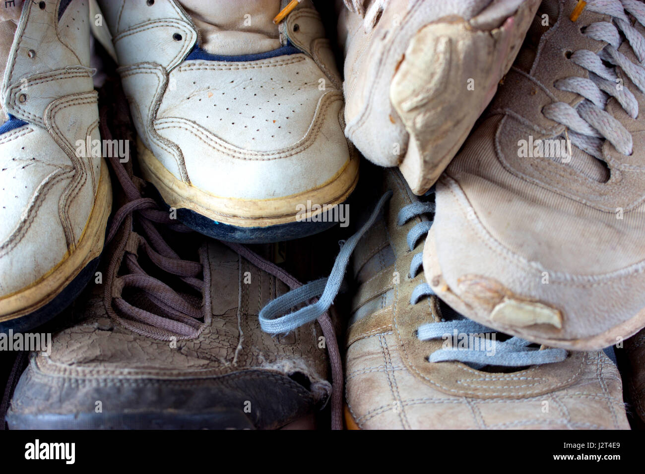 front view from the pairs of old boots Stock Photo - Alamy