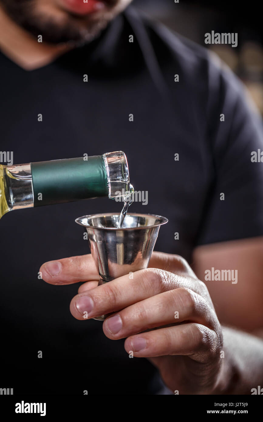 Bartender at work in bar pouring drink into measuring glass Stock Photo ...