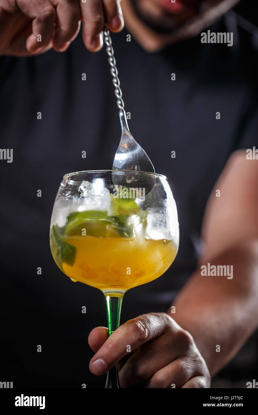 Bartender is stirring cocktails on bar counter Stock Photo - Alamy