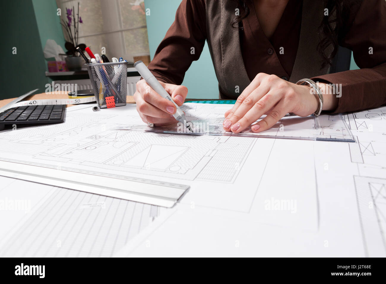 Hands of architect woman working on blueprints Stock Photo - Alamy