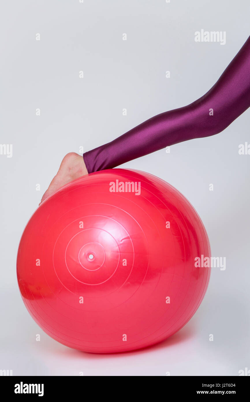 Young woman exercise with red pilates ball isolated on white Stock ...