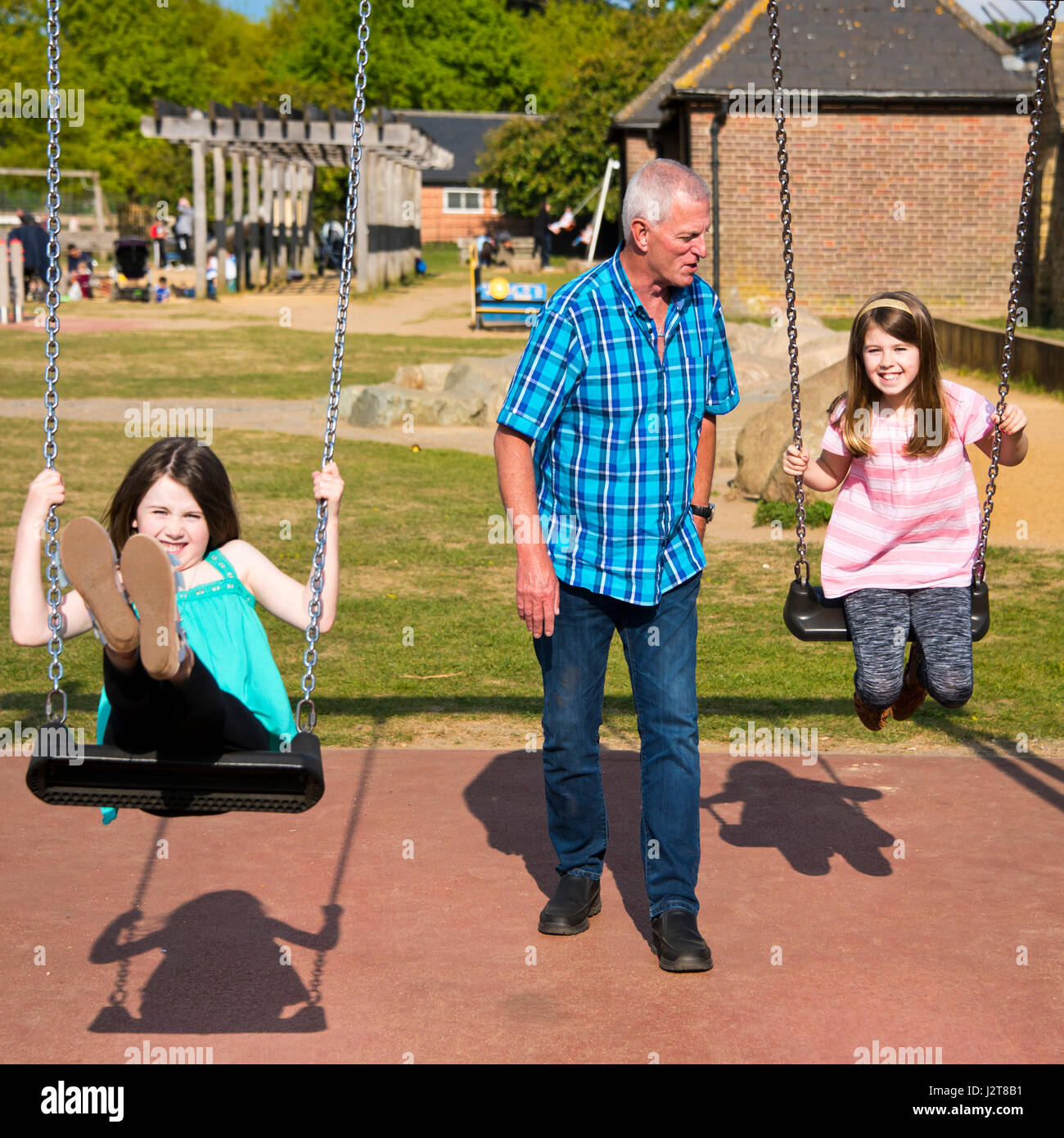 Children being pushed on swings hi-res stock photography and images - Alamy