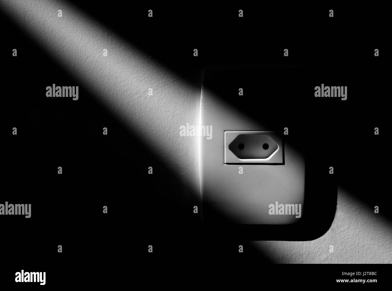 Power outlet illuminated by a beam of sunlight Stock Photo - Alamy