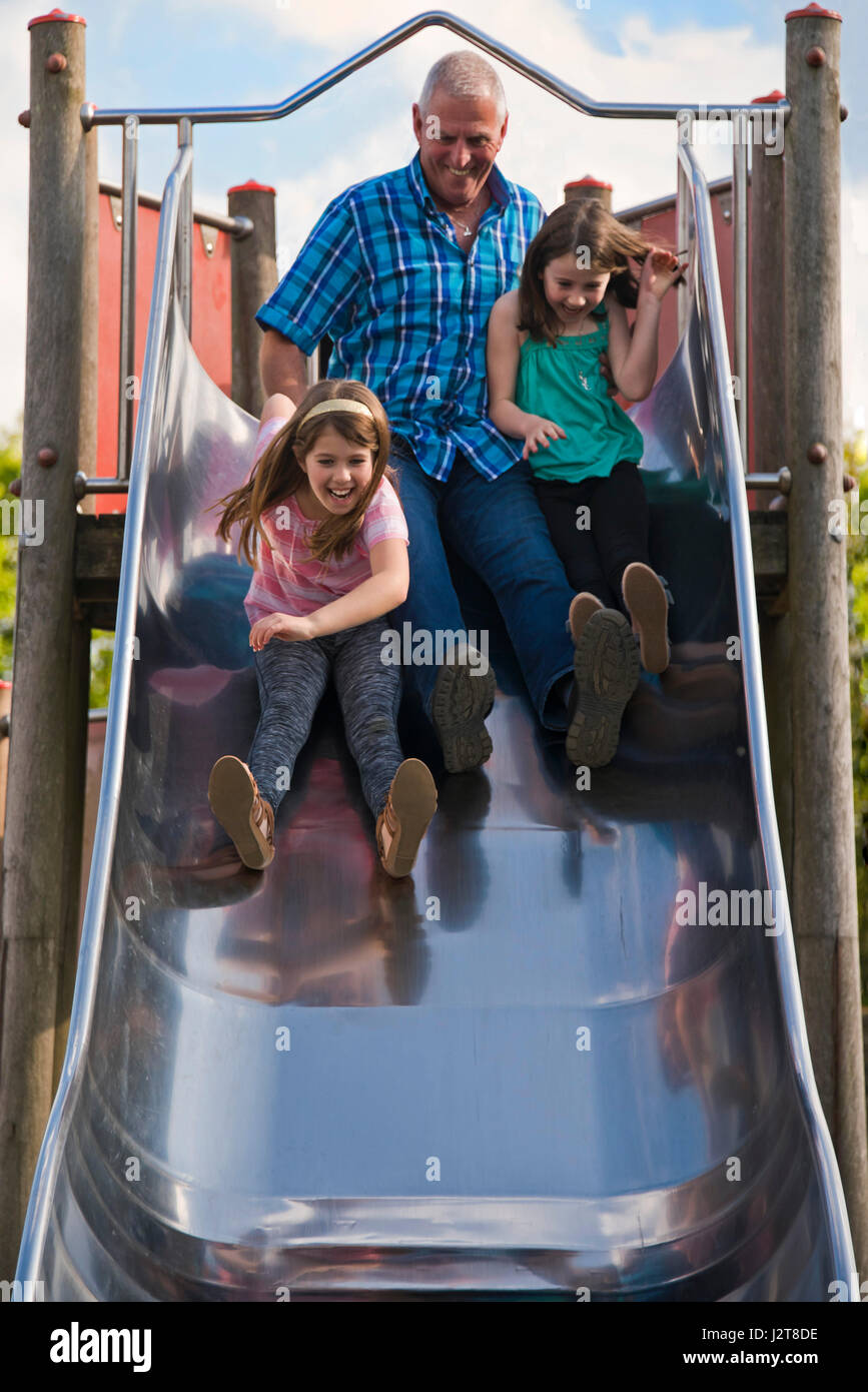 Playground slide man sitting hi-res stock photography and images - Alamy