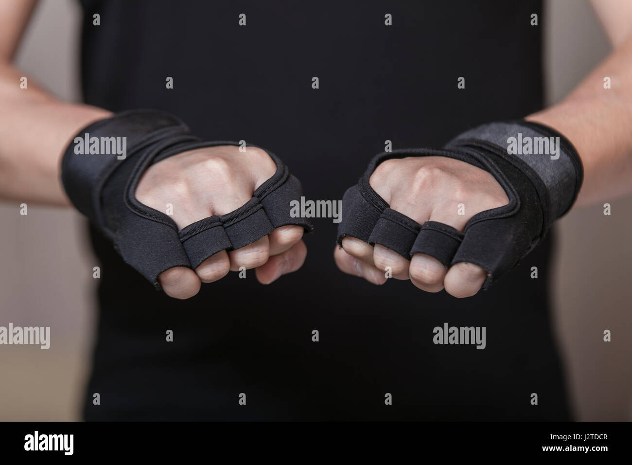 Man's hands put on sports gloves for a gym Stock Photo - Alamy