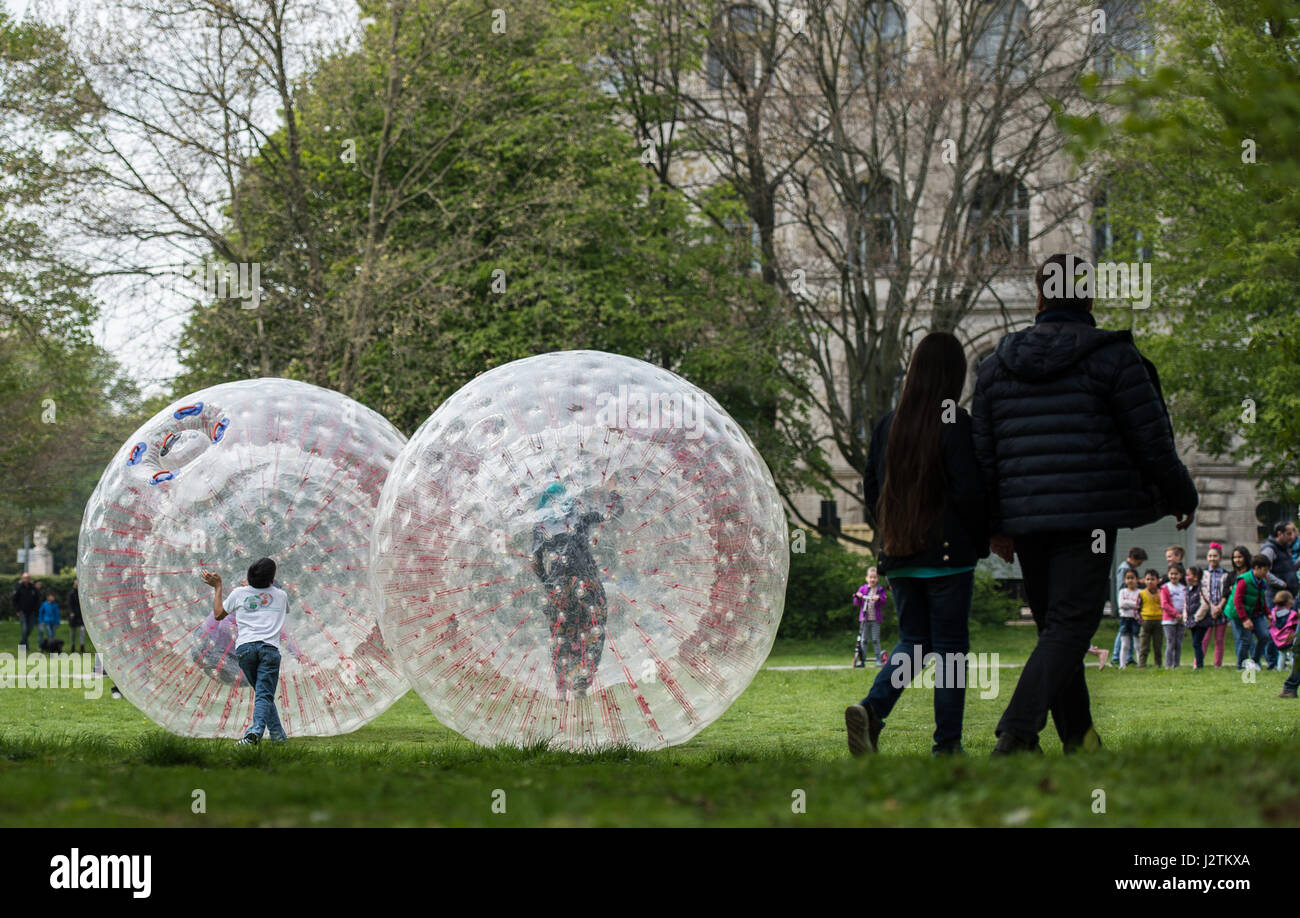 Children playing in so-called Zorb balls on the lawn of the Maschpark ...