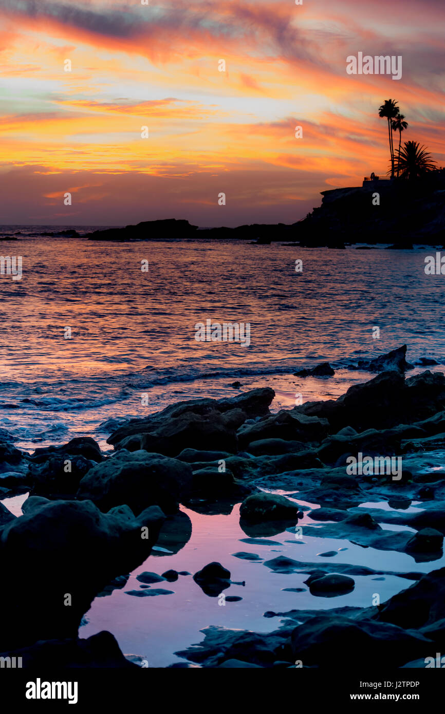 Red and purple sunset at the beach Stock Photo - Alamy