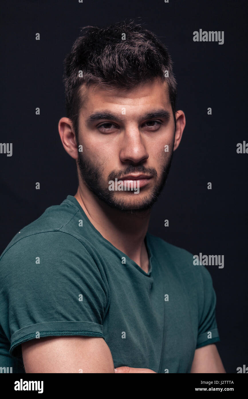one young handsome man, looking at the camera, muscular, side view ...
