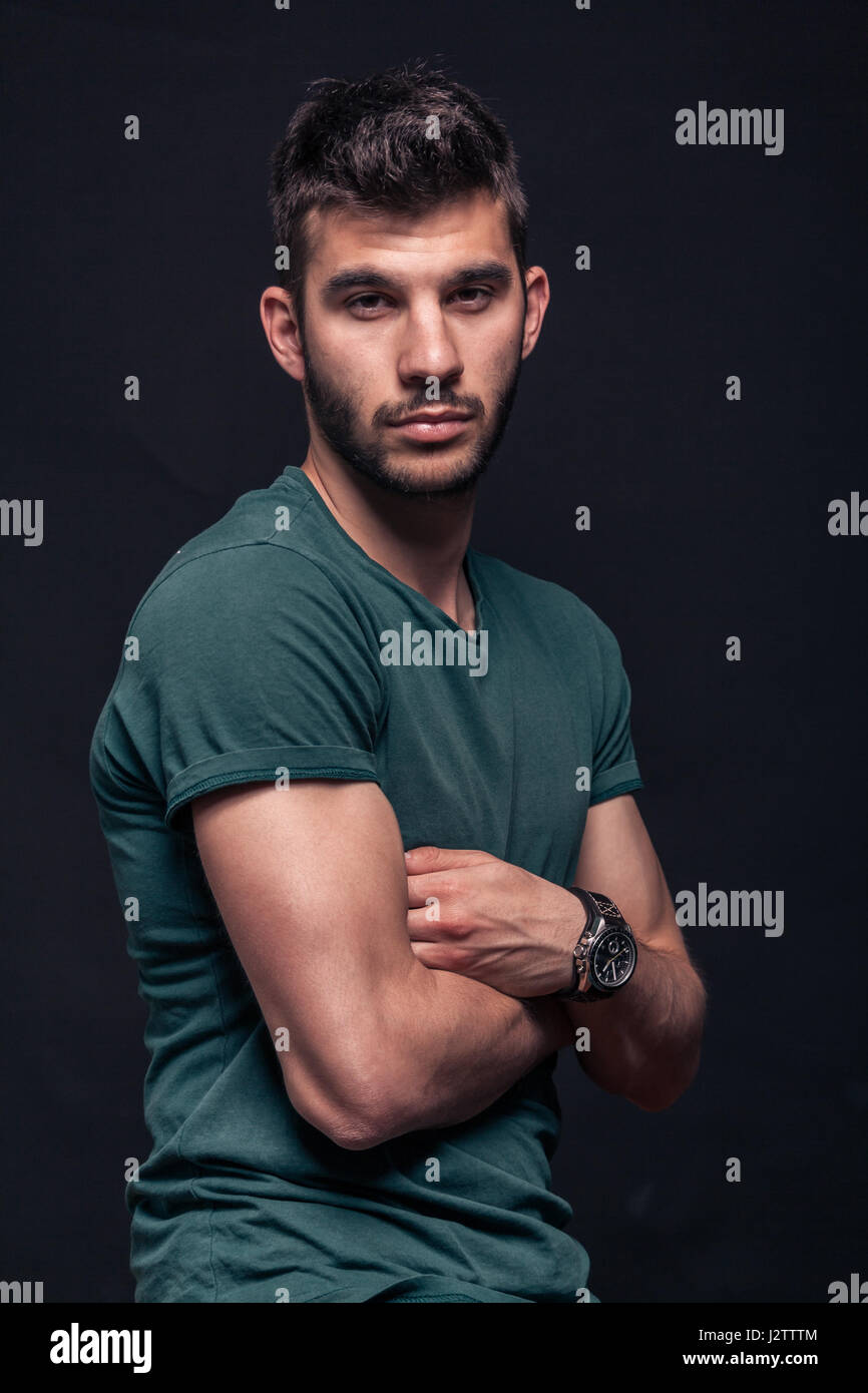 one young handsome man, looking at the camera, muscular, side view ...